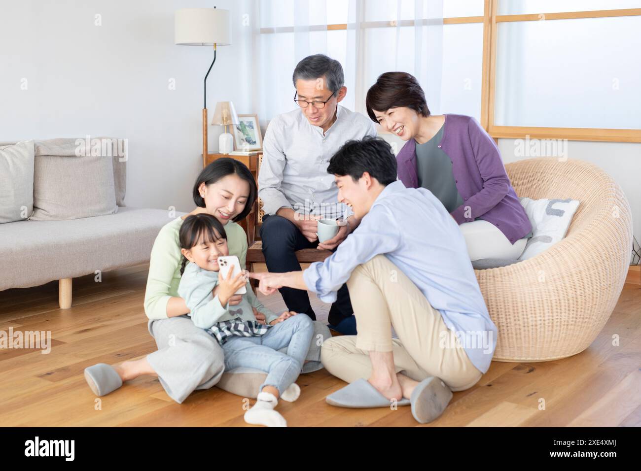 Family of three generations playing with their smartphones in the ...