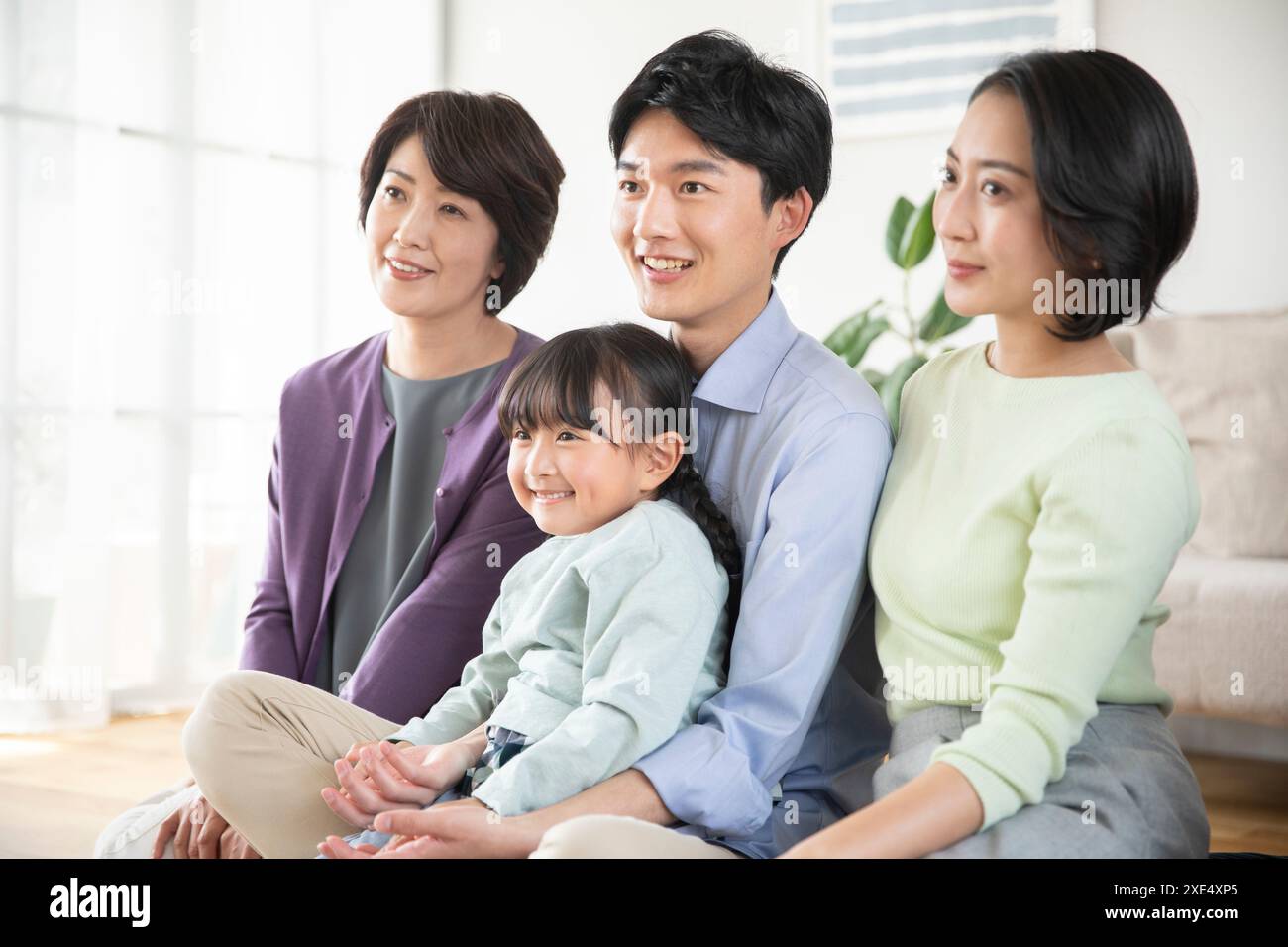 Family of three generations enjoying a meal in the living room Stock ...