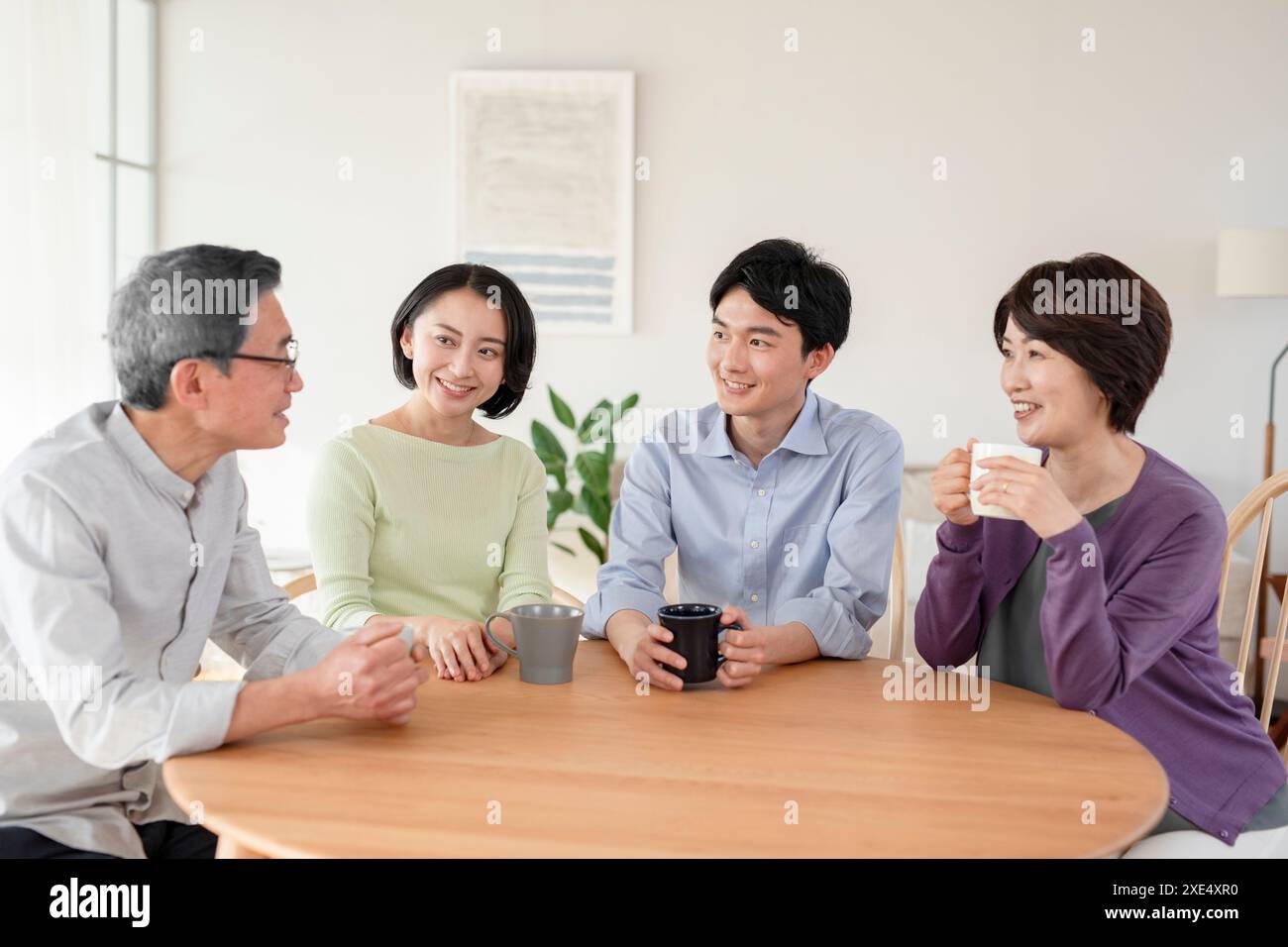 Family of two generations relaxing in the living room Stock Photo - Alamy