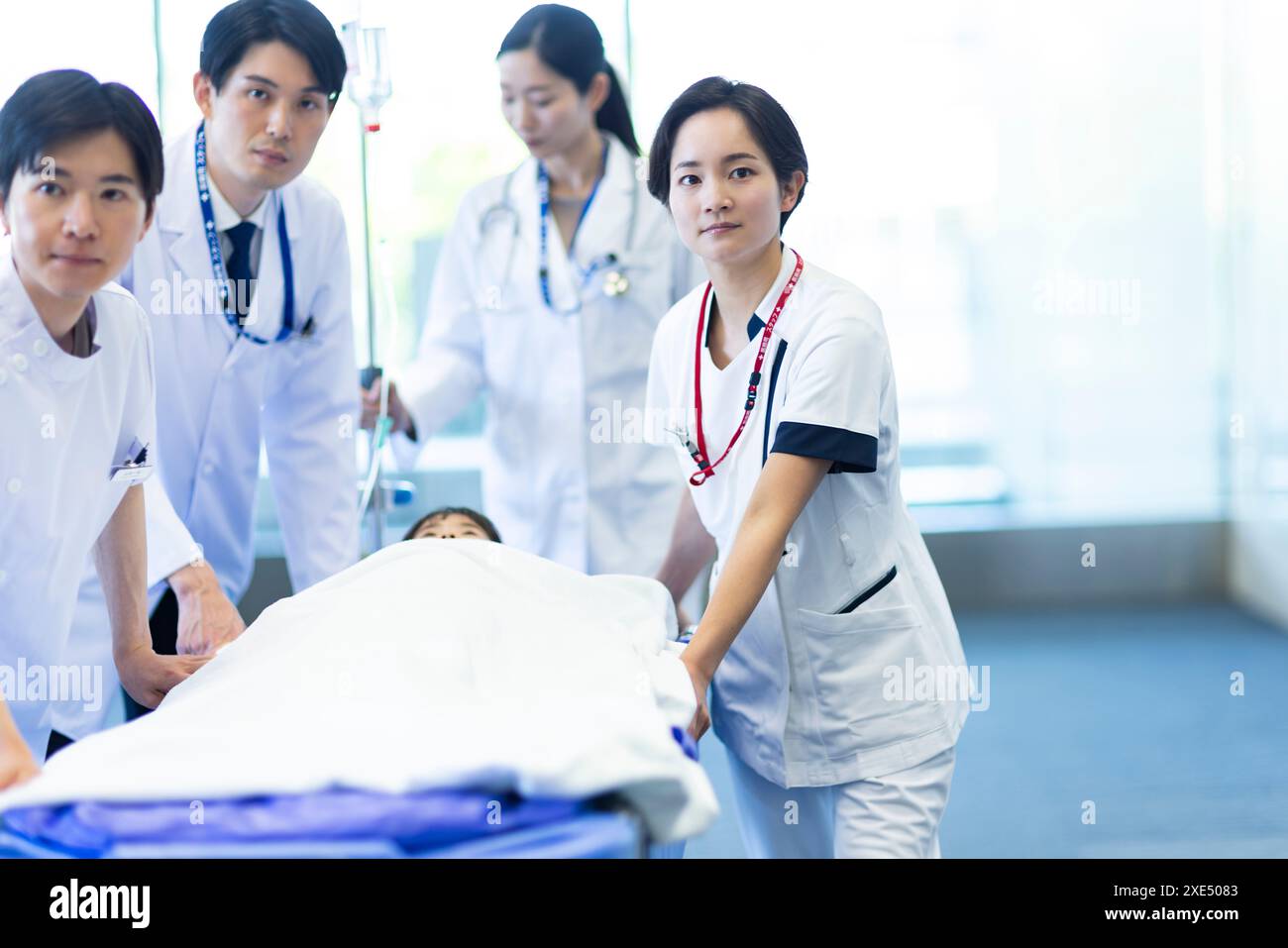 Medical team pushing a stretcher Stock Photo - Alamy