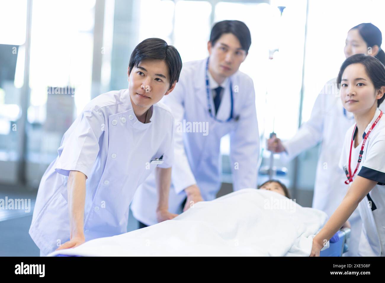 Medical team pushing a stretcher Stock Photo - Alamy