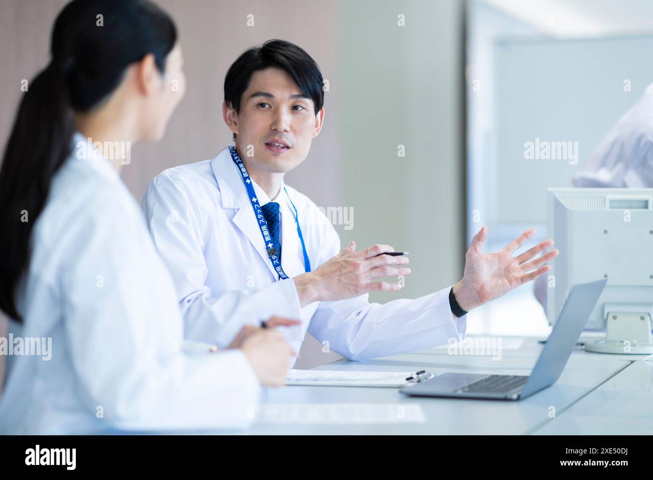 Young doctor working documents computer hi-res stock photography and ...