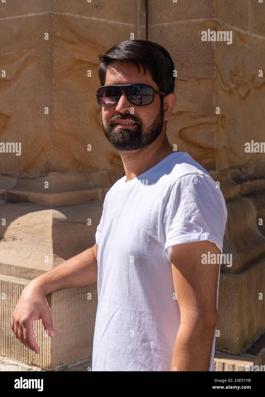 Close-up portrait of a modern Pakistani man with a dark beard, light ...