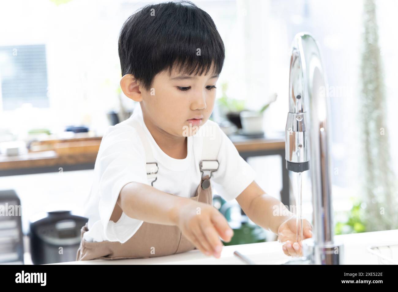 Boy washing his hands Stock Photo - Alamy