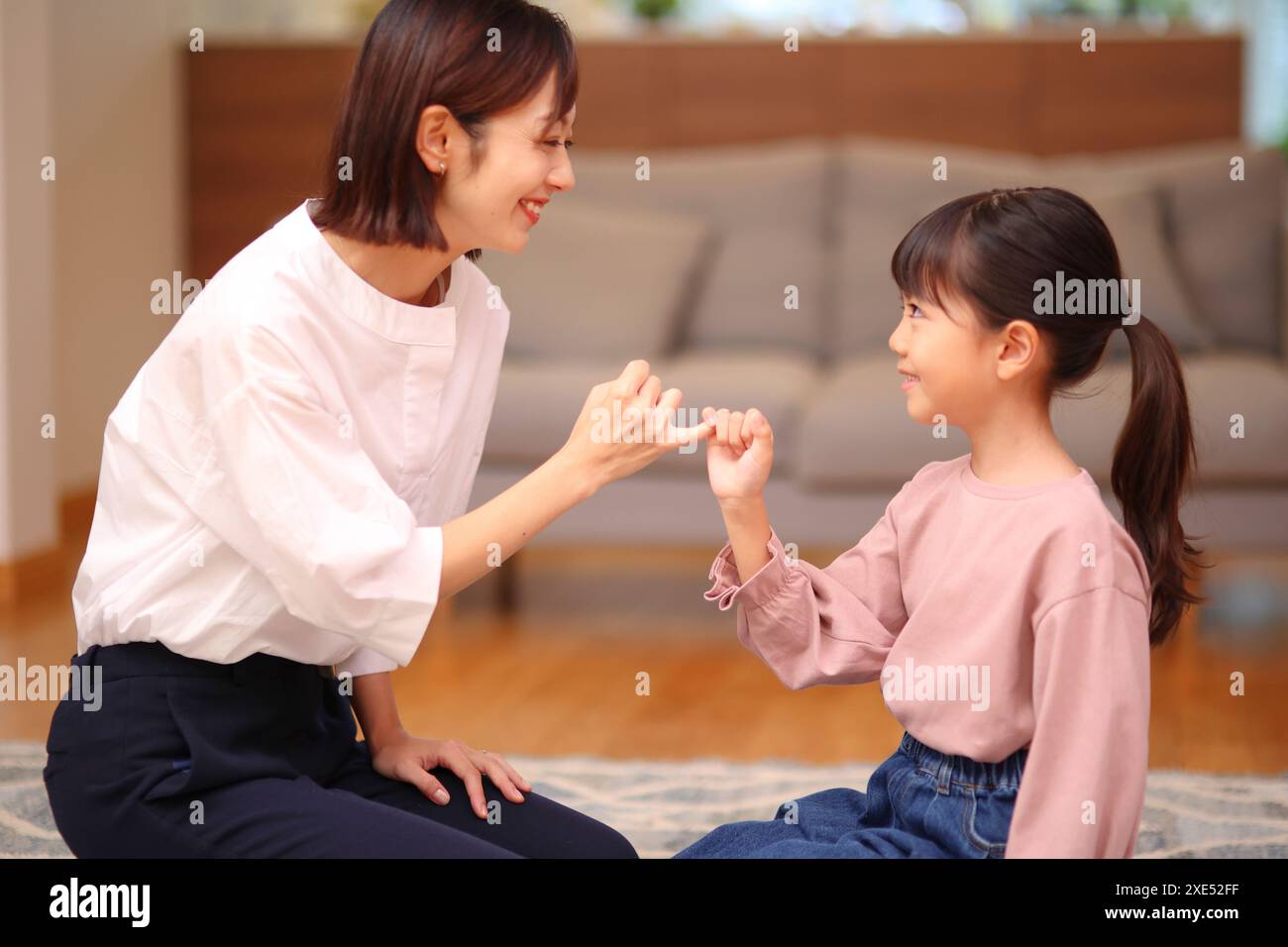 Mother and daughter doing finger-slicing Stock Photo - Alamy