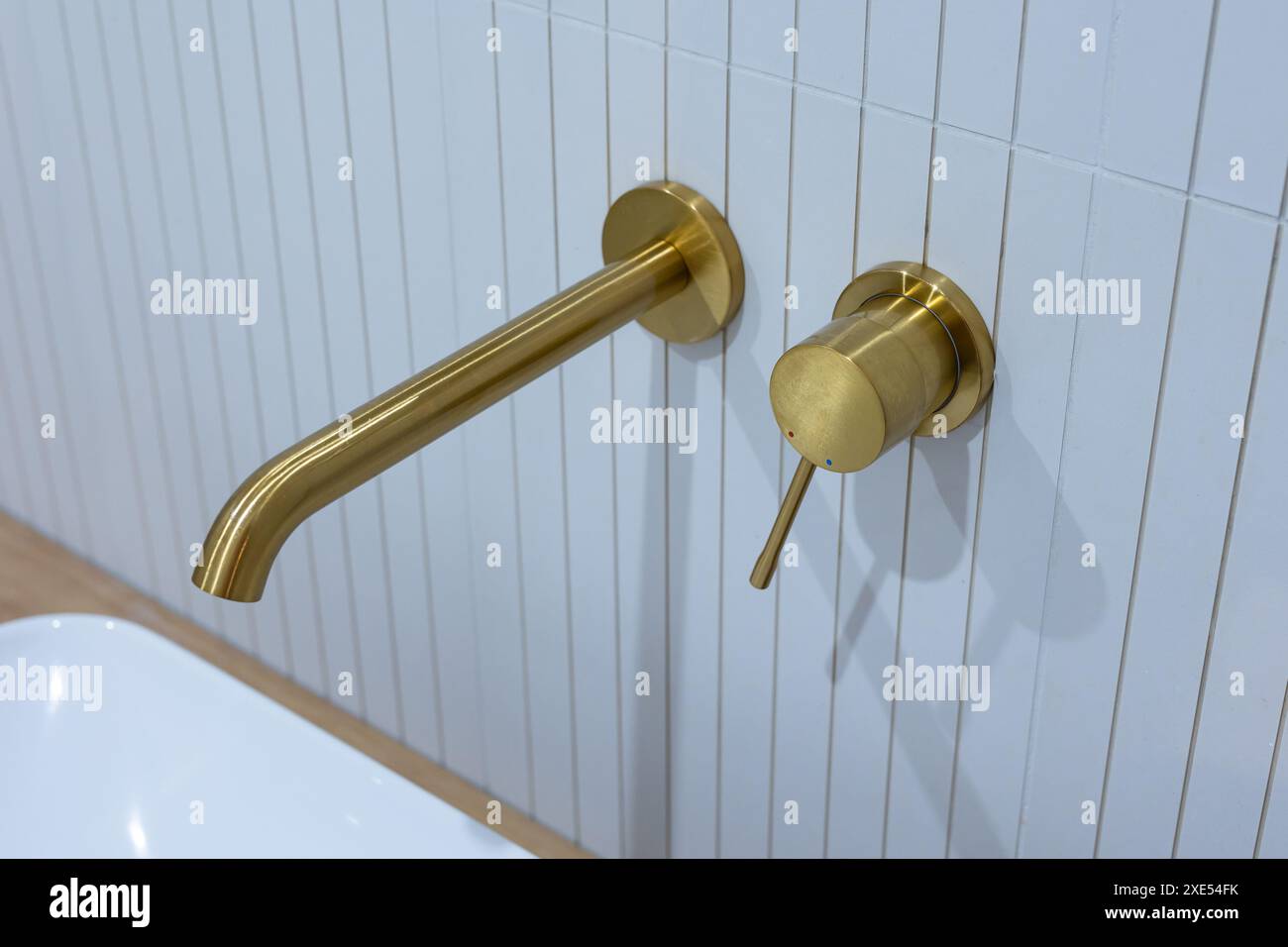 Bronze bathroom water tap in a bathroom finished with white tiles ...