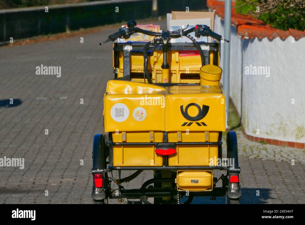 Mail delivery by e-bike Stock Photo - Alamy