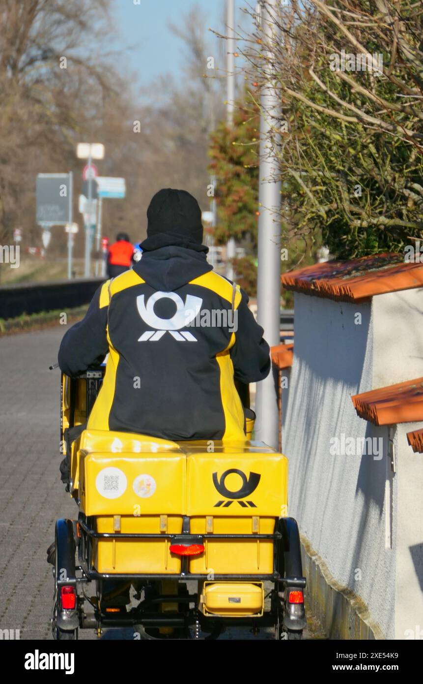 Mail delivery by e-bike Stock Photo - Alamy