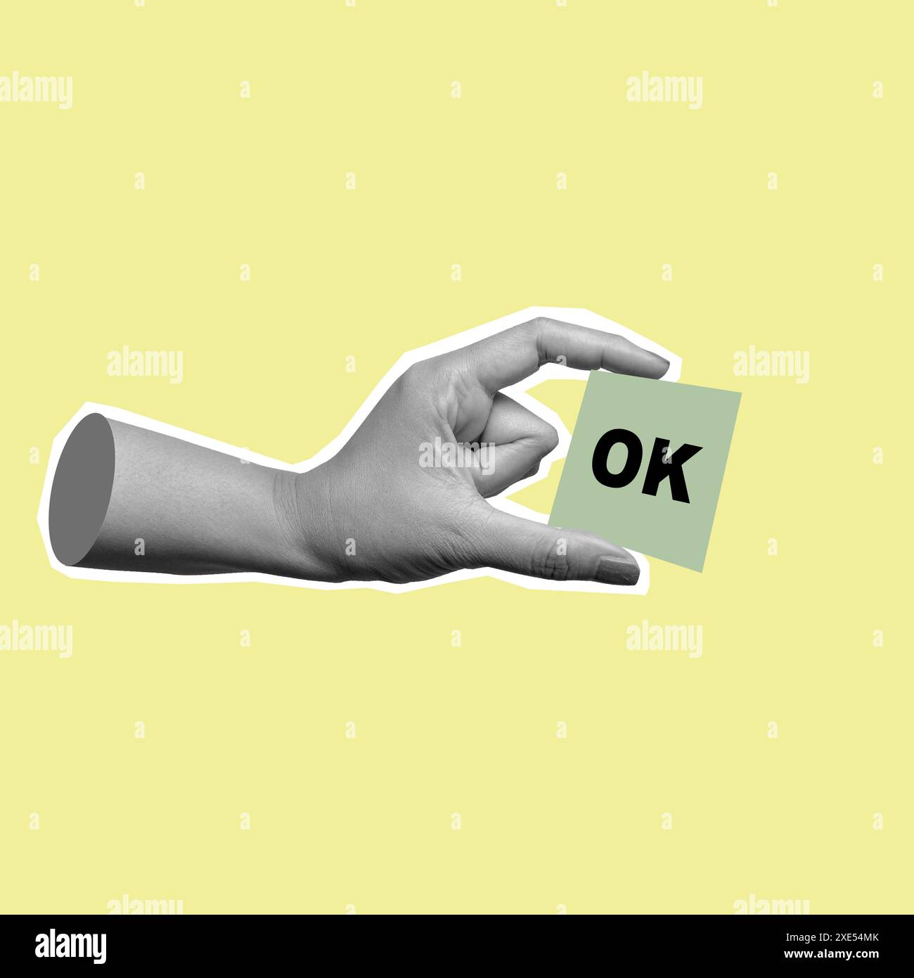A human hand holding note paper with ok text on a colored background ...
