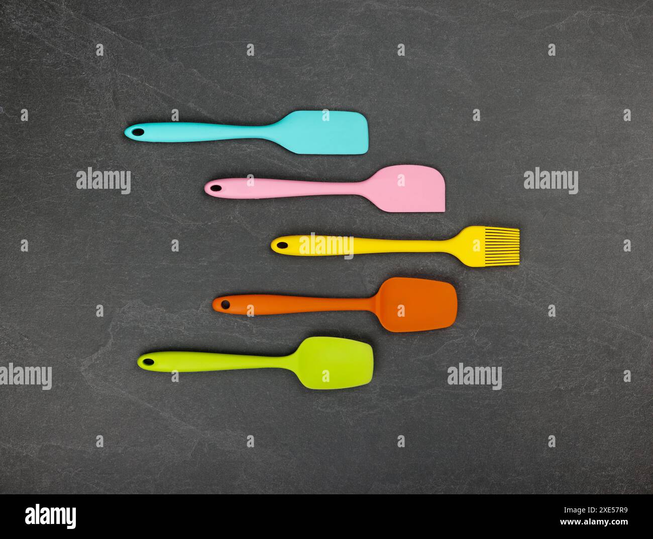Silicone culinary spatulas and brushes on black Stock Photo - Alamy