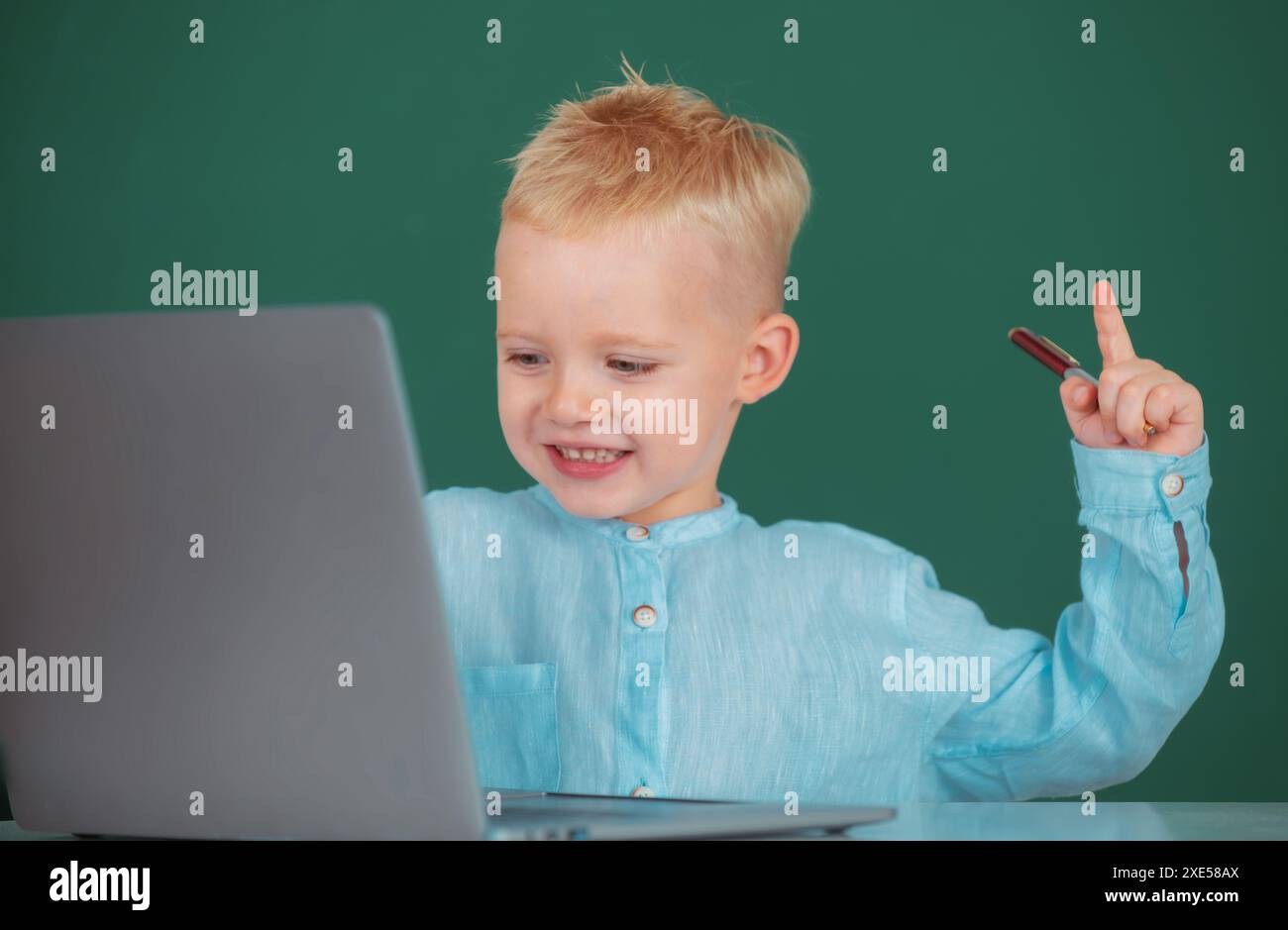 Cute excited school kid boy study in a classroom. Genius child ...