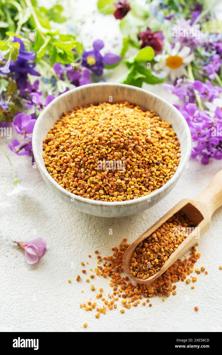 Healthy bee pollen grains. Bee pollen on a bowl and wild flowers Stock ...