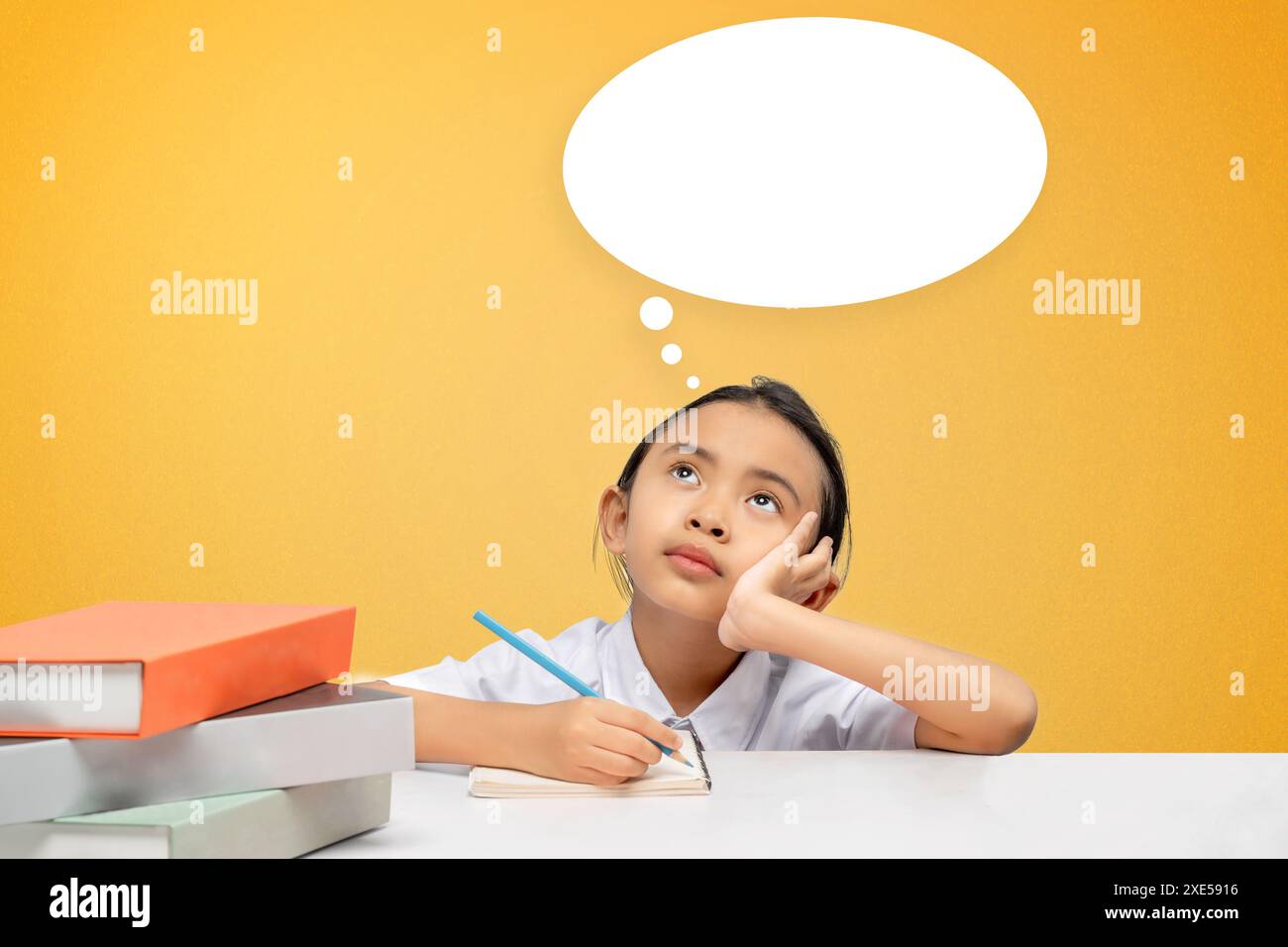 Portrait of an Asian elementary school student girl with a stack of ...
