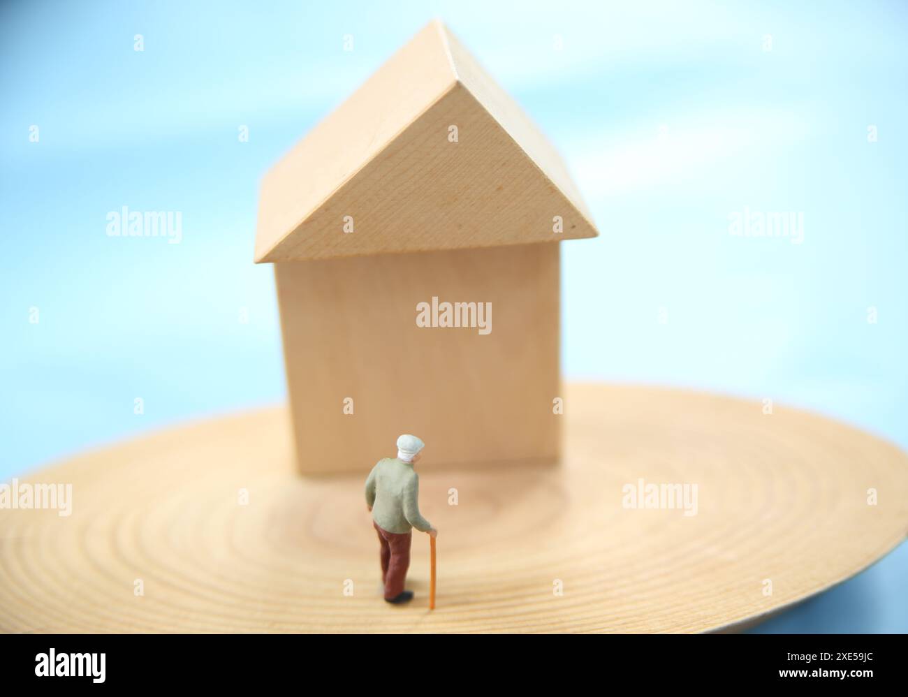 Miniature old man and wooden house Stock Photo - Alamy