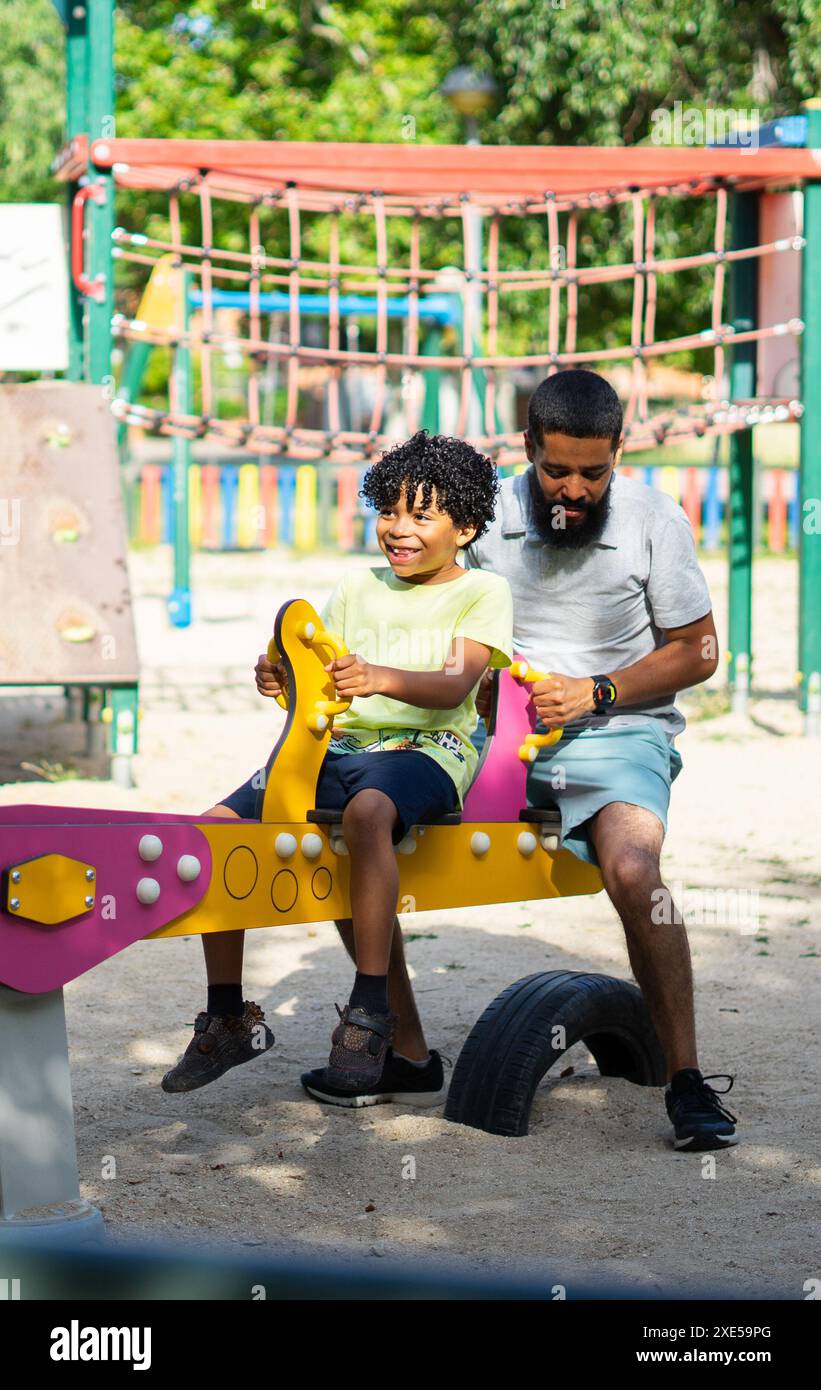Father son playing playground hi-res stock photography and images - Alamy
