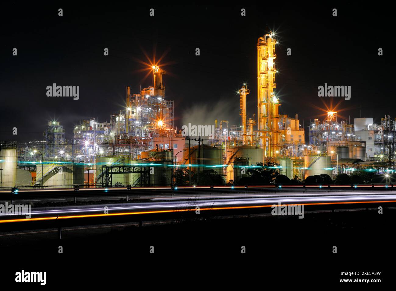 Light traces and night view of factory Stock Photo - Alamy