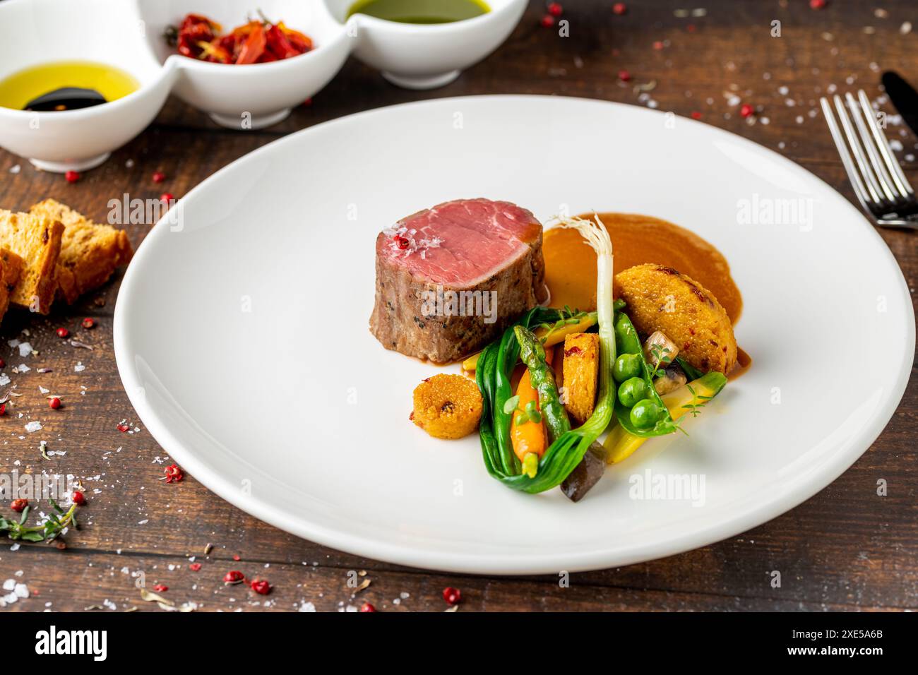 Filet mignon served with vegetables and sauces at a fine dining ...