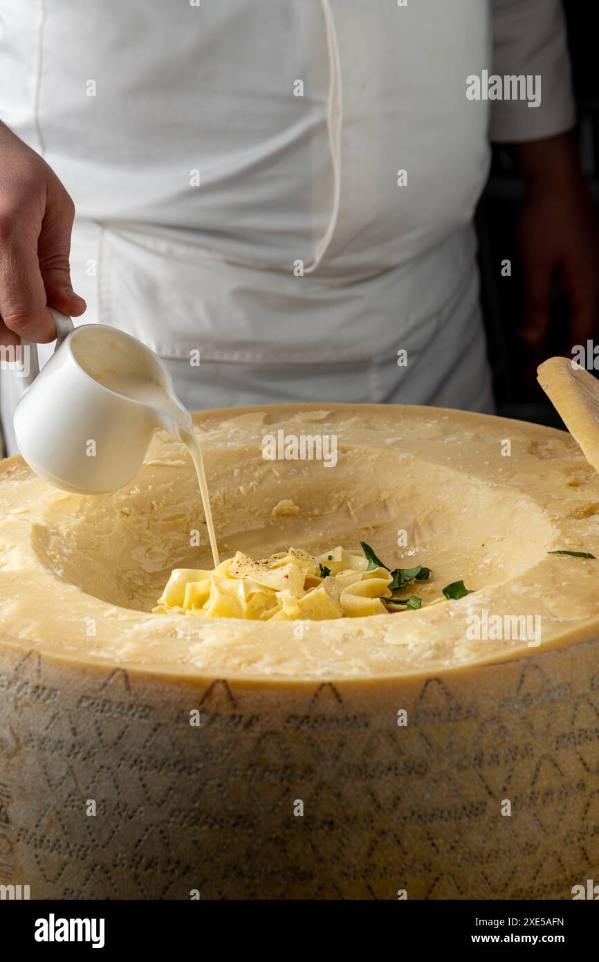Fresh pasta with sauce in a whole parmesan wheel Stock Photo - Alamy