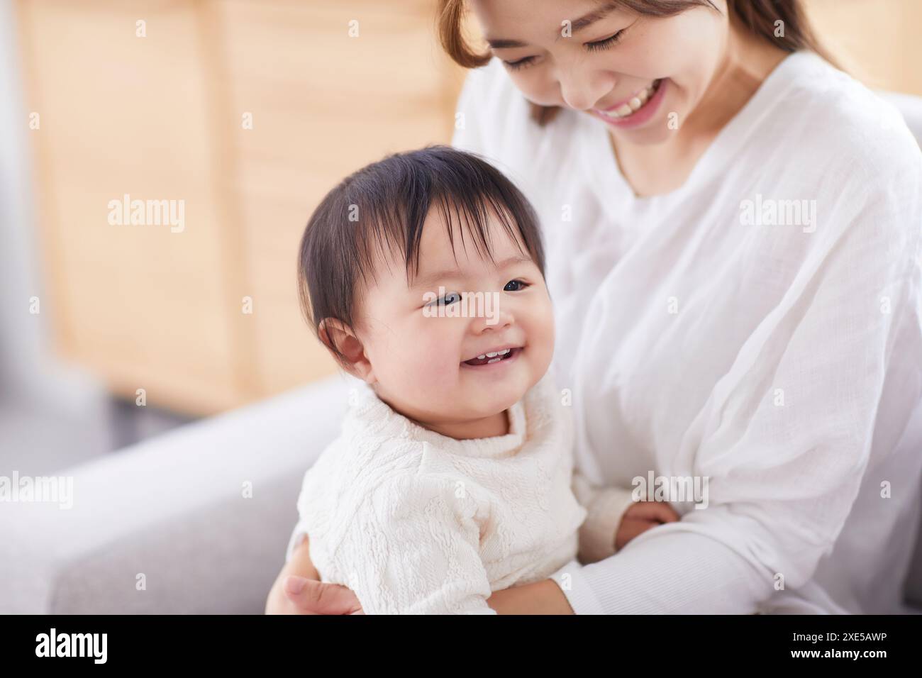 Parent and child relaxing in the living room Stock Photo - Alamy