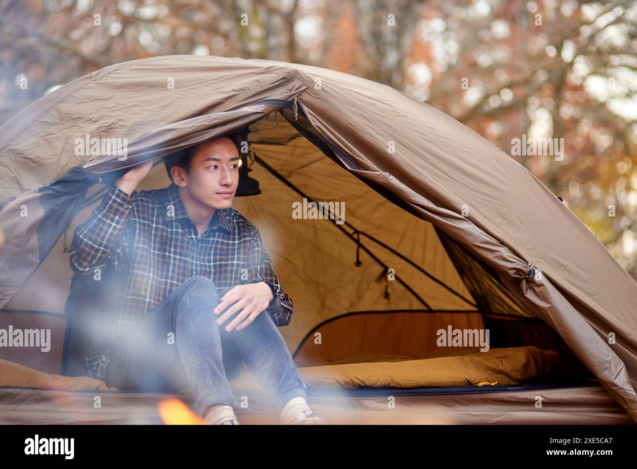 Young Japanese man enjoying solo camping Stock Photo - Alamy