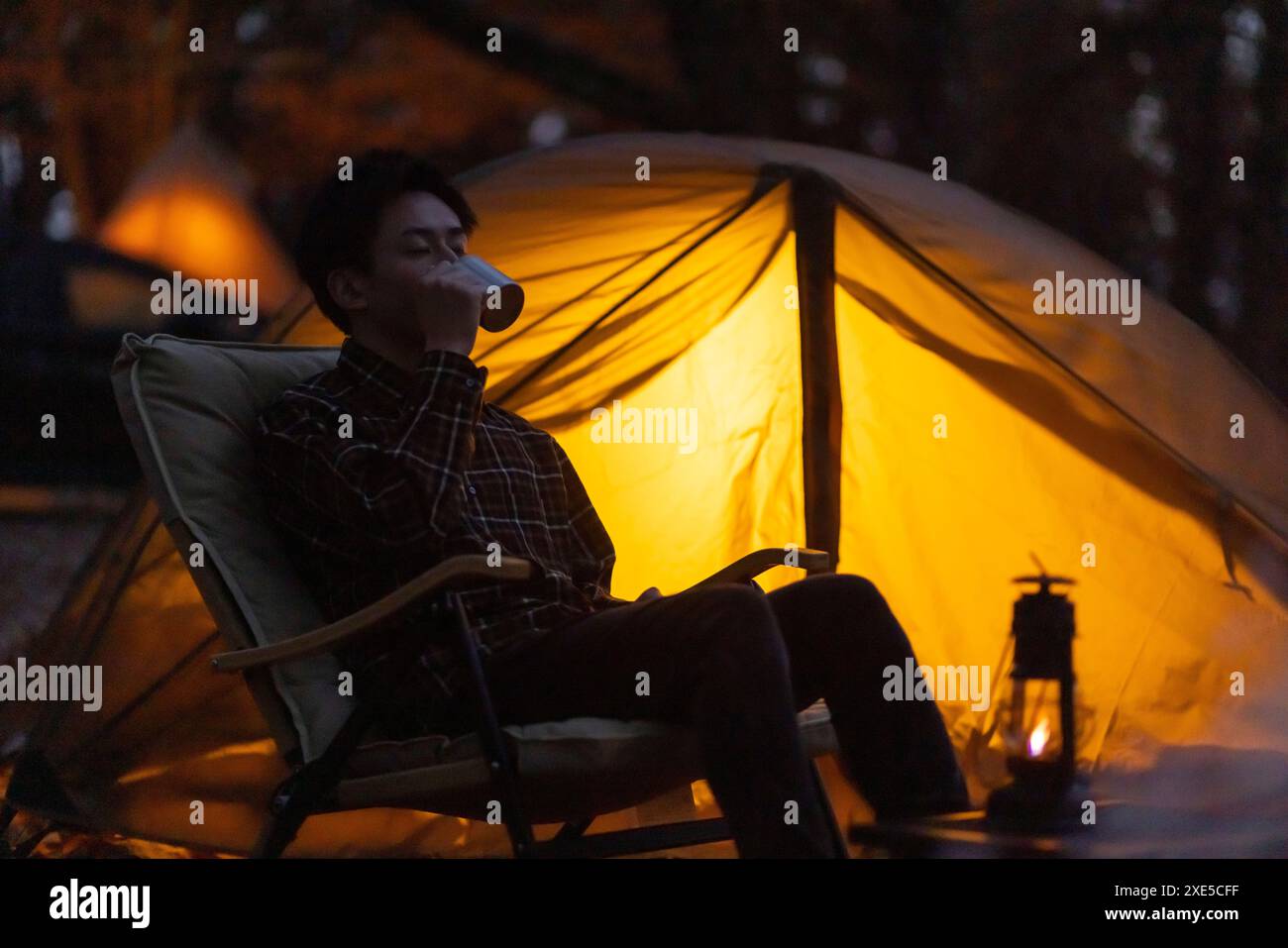 Young Japanese man enjoying solo camping Stock Photo - Alamy