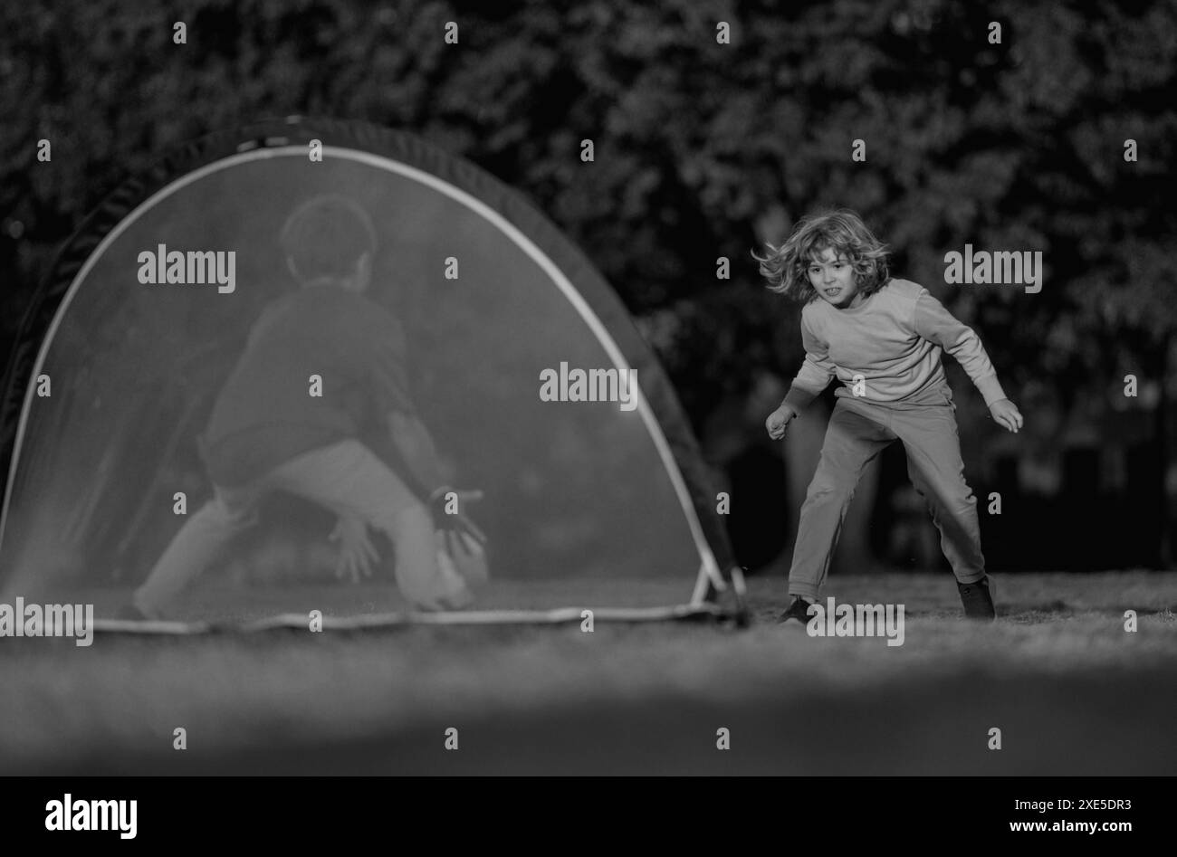 Child boy hold classic football ball in park. Kid hold football ball ...