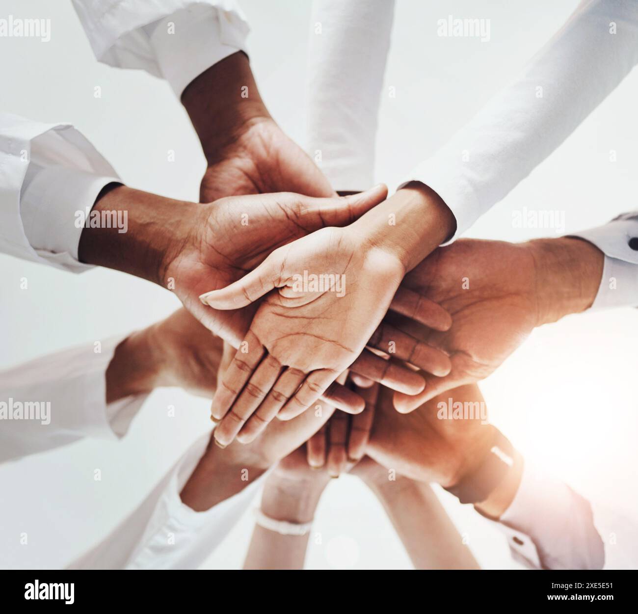 Below, hands stack and medical people in hospital for healthcare support, solidarity and ...