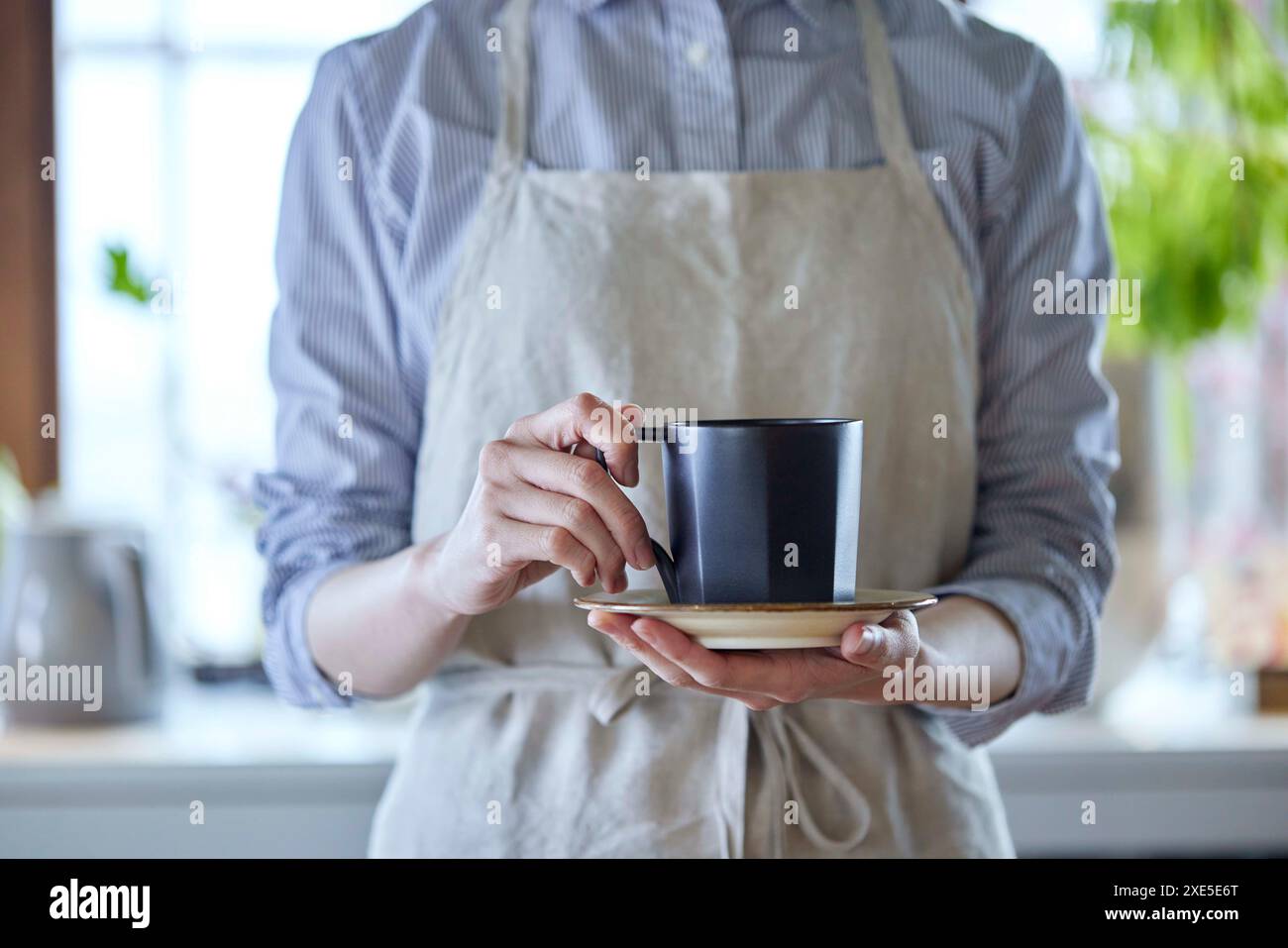 Young Japanese woman carrying coffee Stock Photo - Alamy