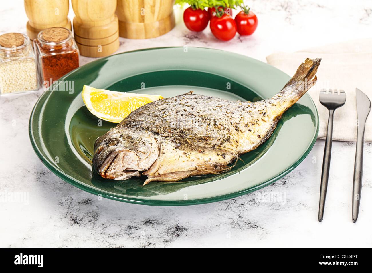 Baked Dorado fish served lemon slice Stock Photo - Alamy