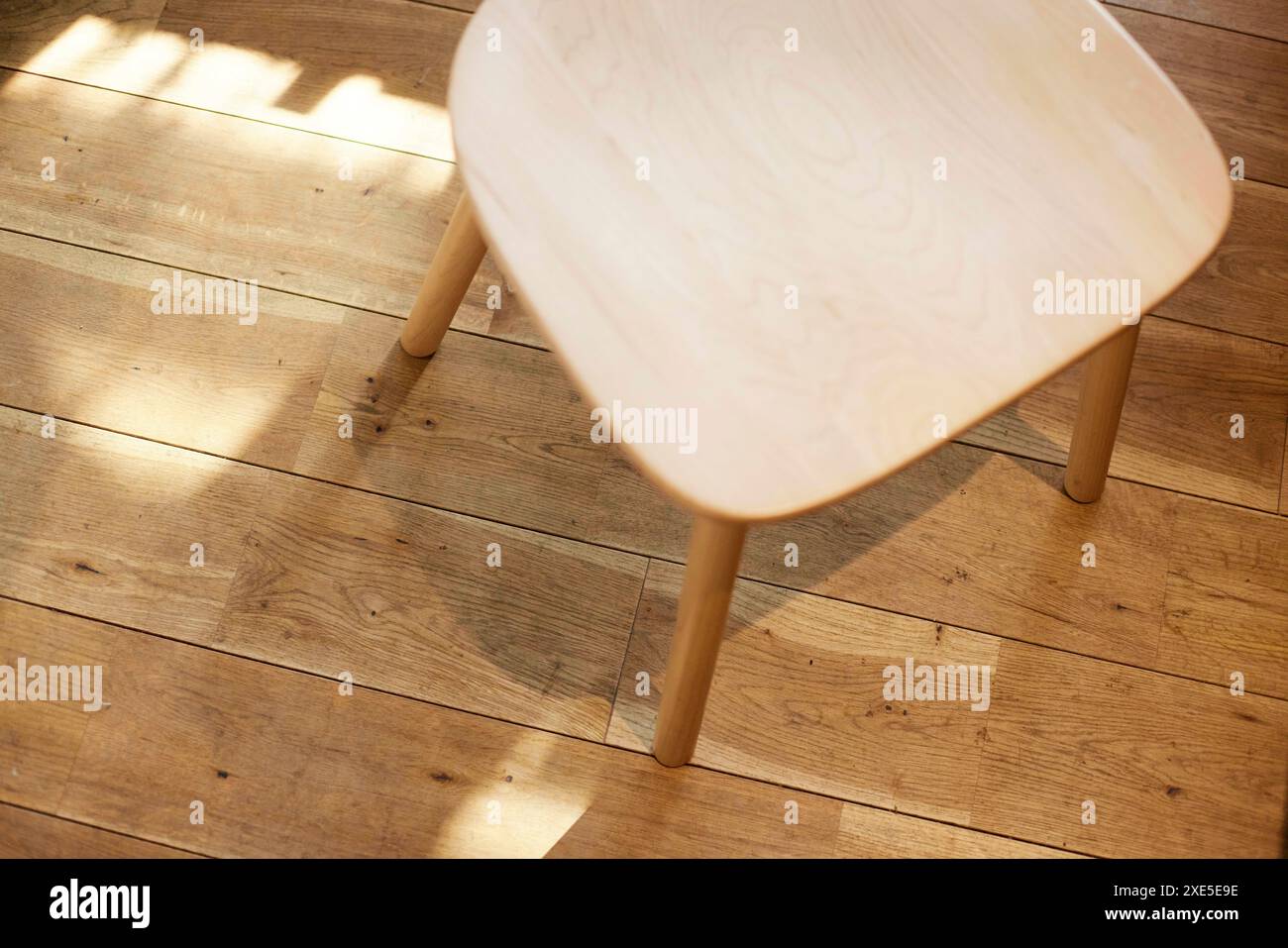 Wooden chairs on the living room flooring Stock Photo - Alamy