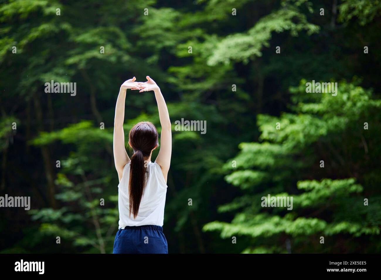 Japanese woman stretching in nature Stock Photo - Alamy