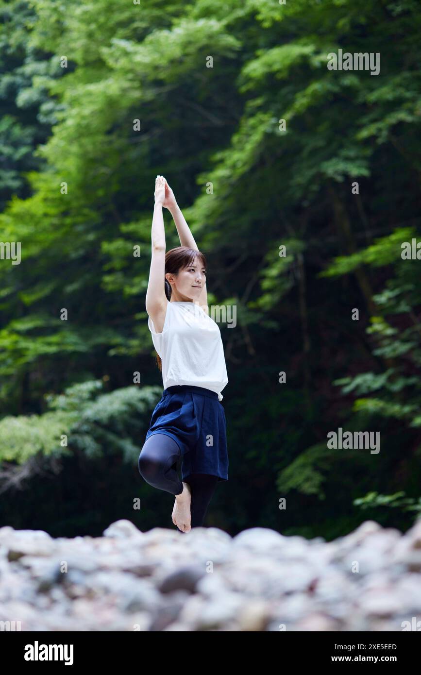 Japanese woman stretching in nature Stock Photo - Alamy