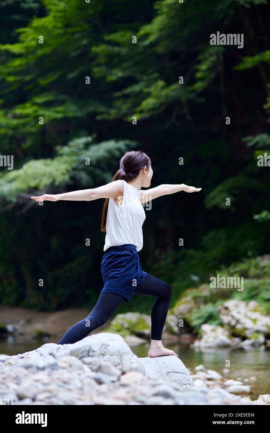 Japanese woman stretching in nature Stock Photo - Alamy