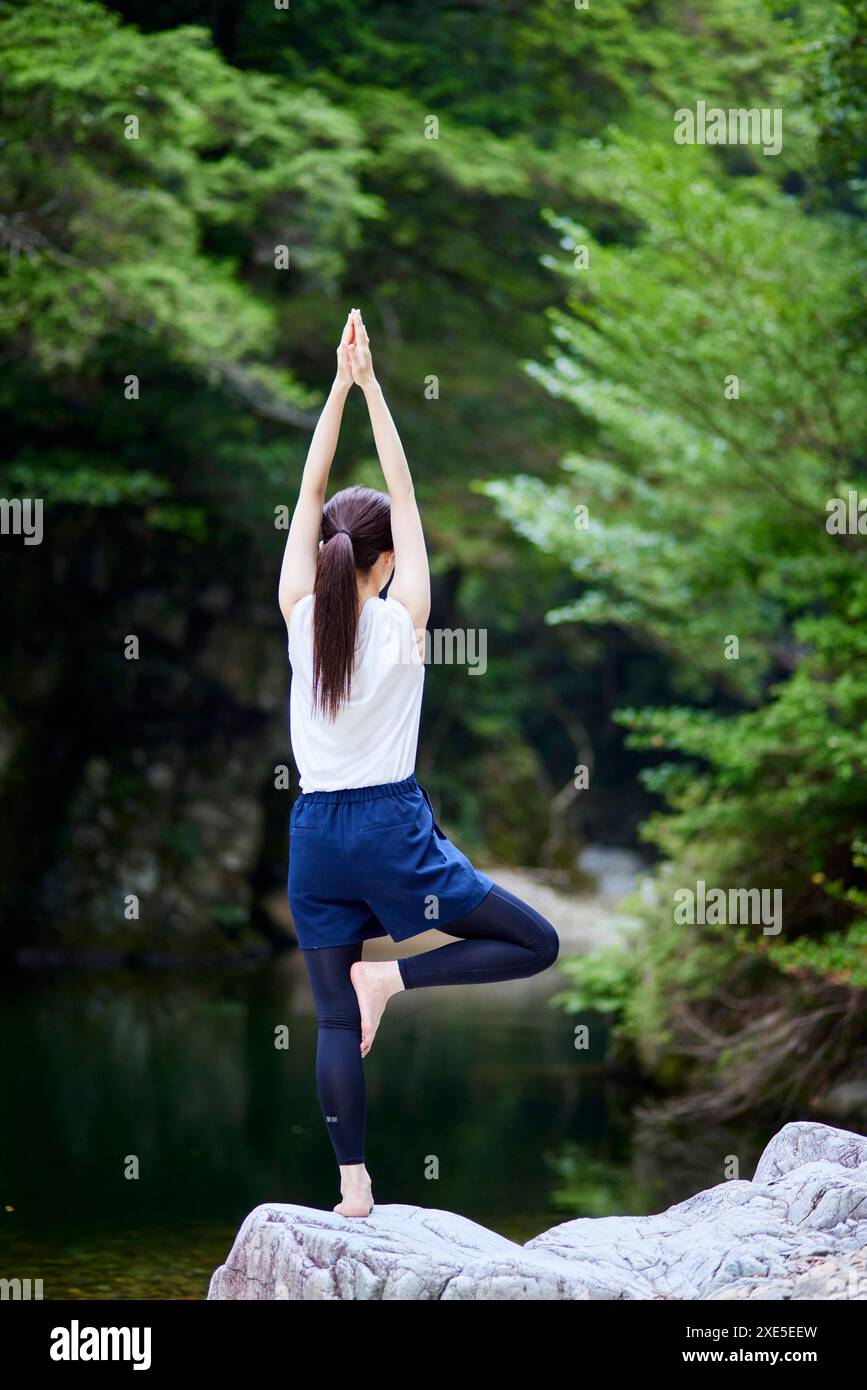 Japanese woman stretching in nature Stock Photo - Alamy