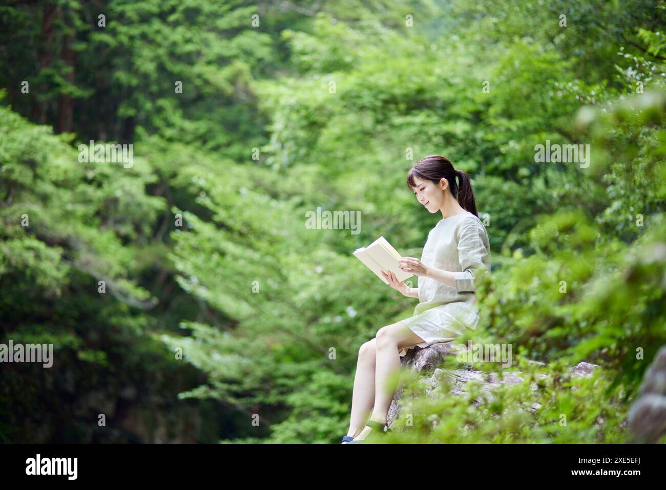 Japanese woman reading in nature Stock Photo - Alamy