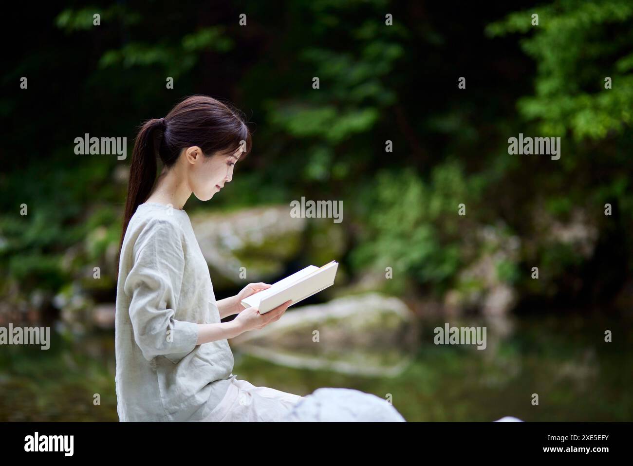 Japanese woman reading in nature Stock Photo - Alamy