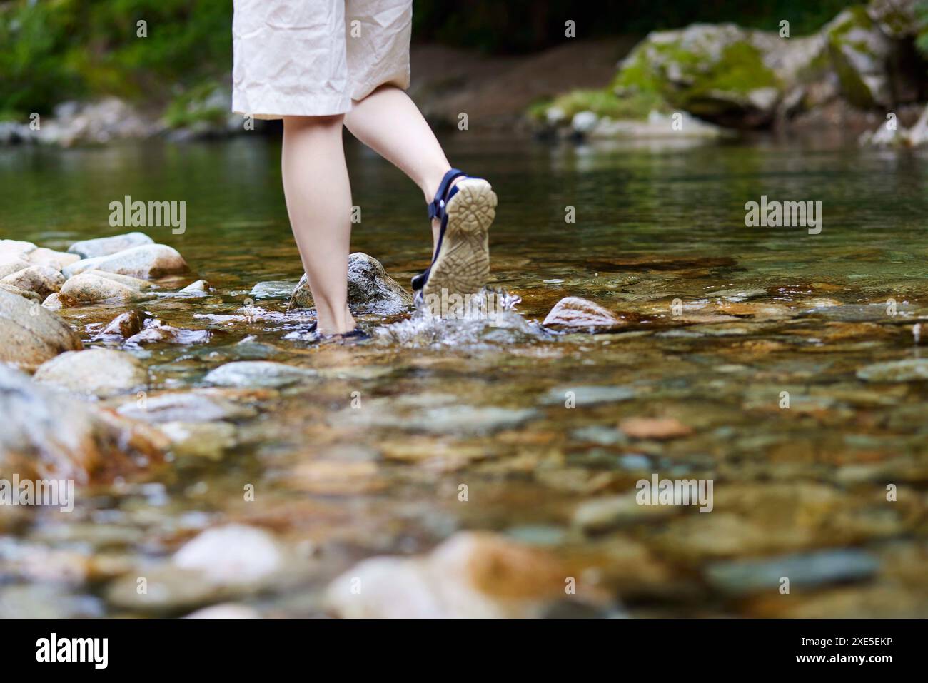 Young woman's feet soaking in the river Stock Photo - Alamy
