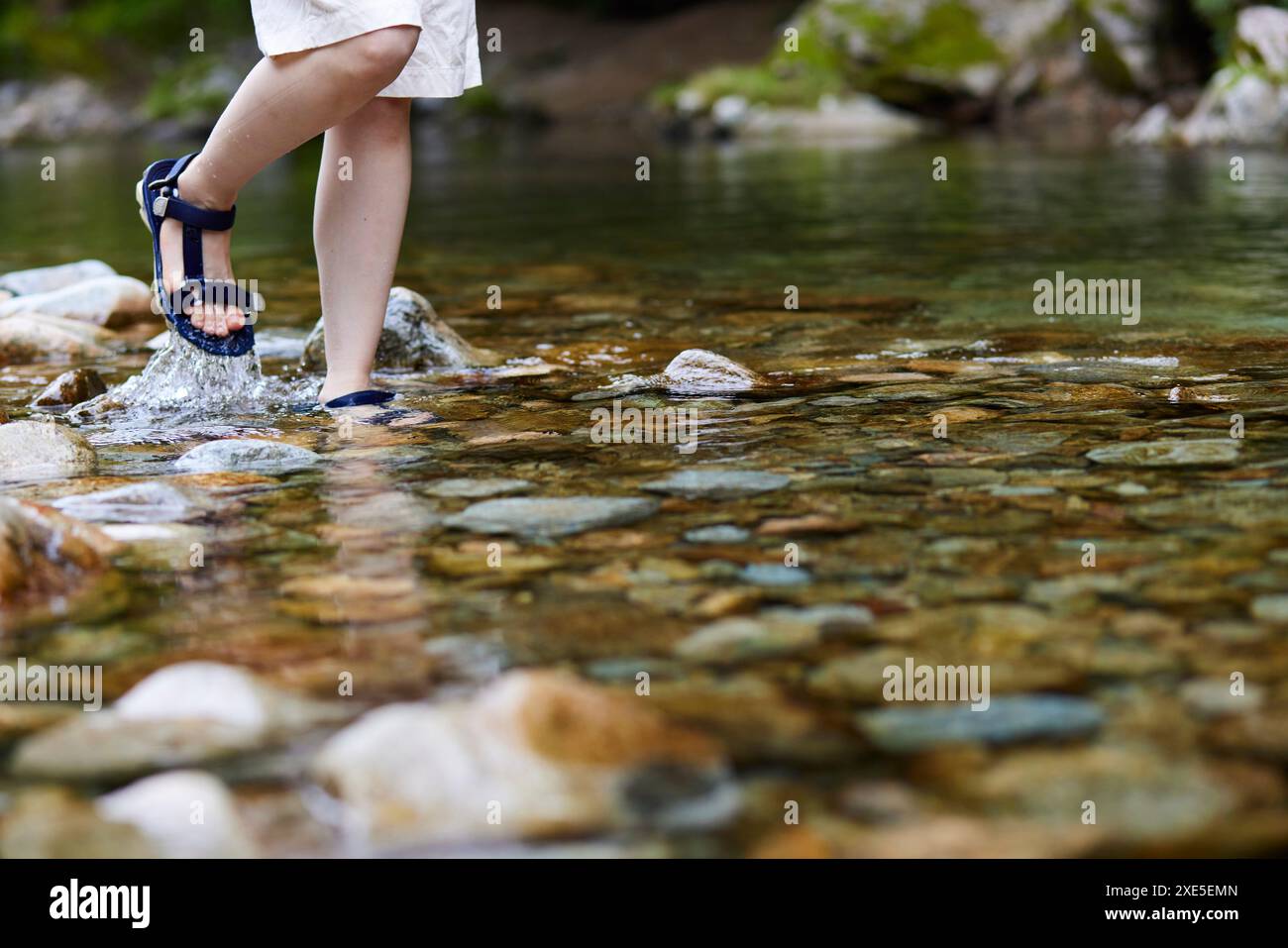 Young woman's feet soaking in the river Stock Photo - Alamy