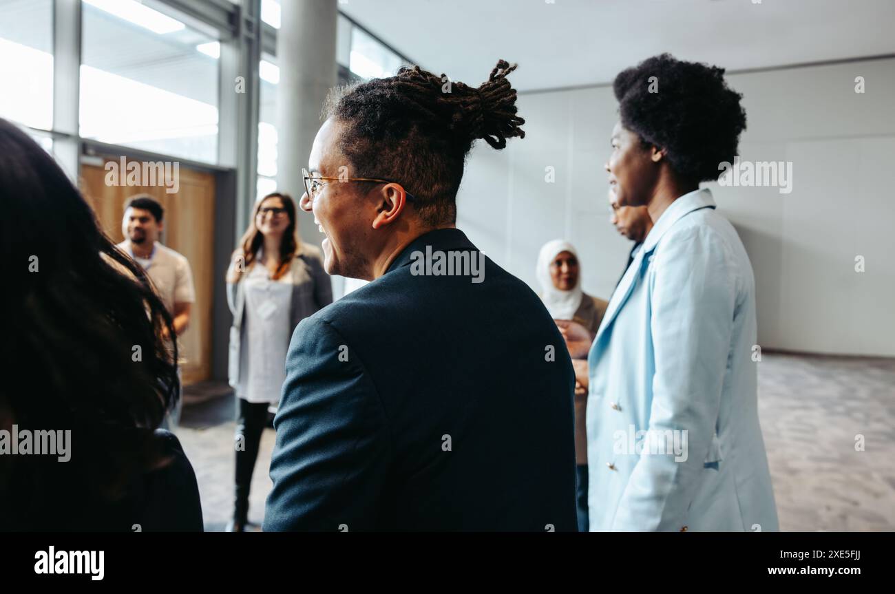 Diverse group of professionals engaged in conversation during a ...