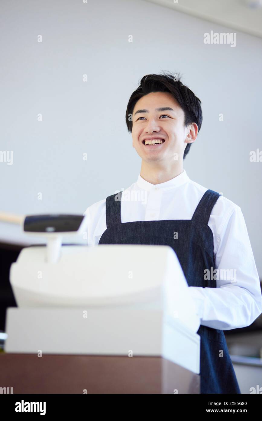 Young Japanese man working in café Stock Photo - Alamy