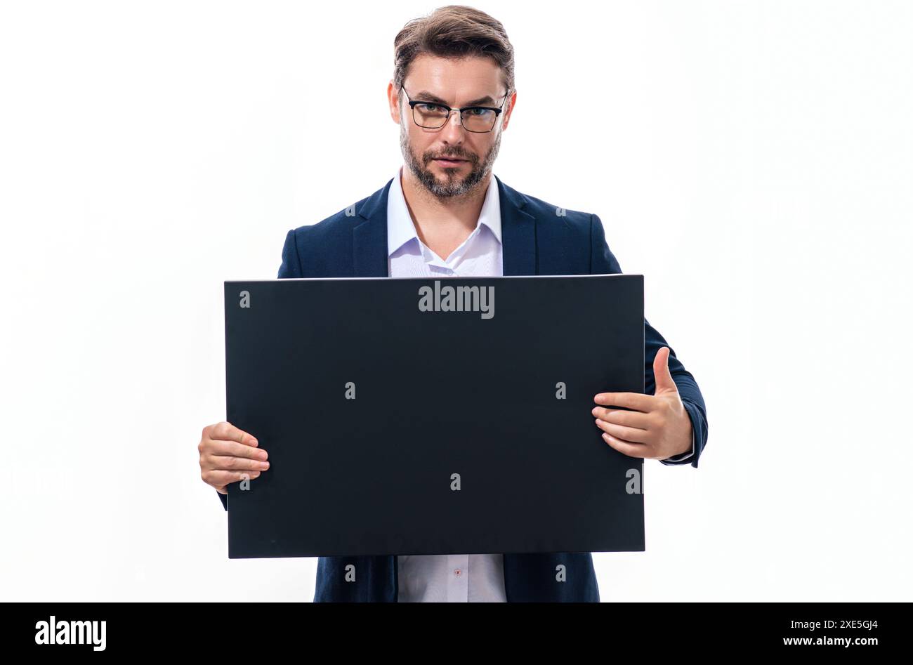 Serious man with blank banner ad, posing isolated over studio ...