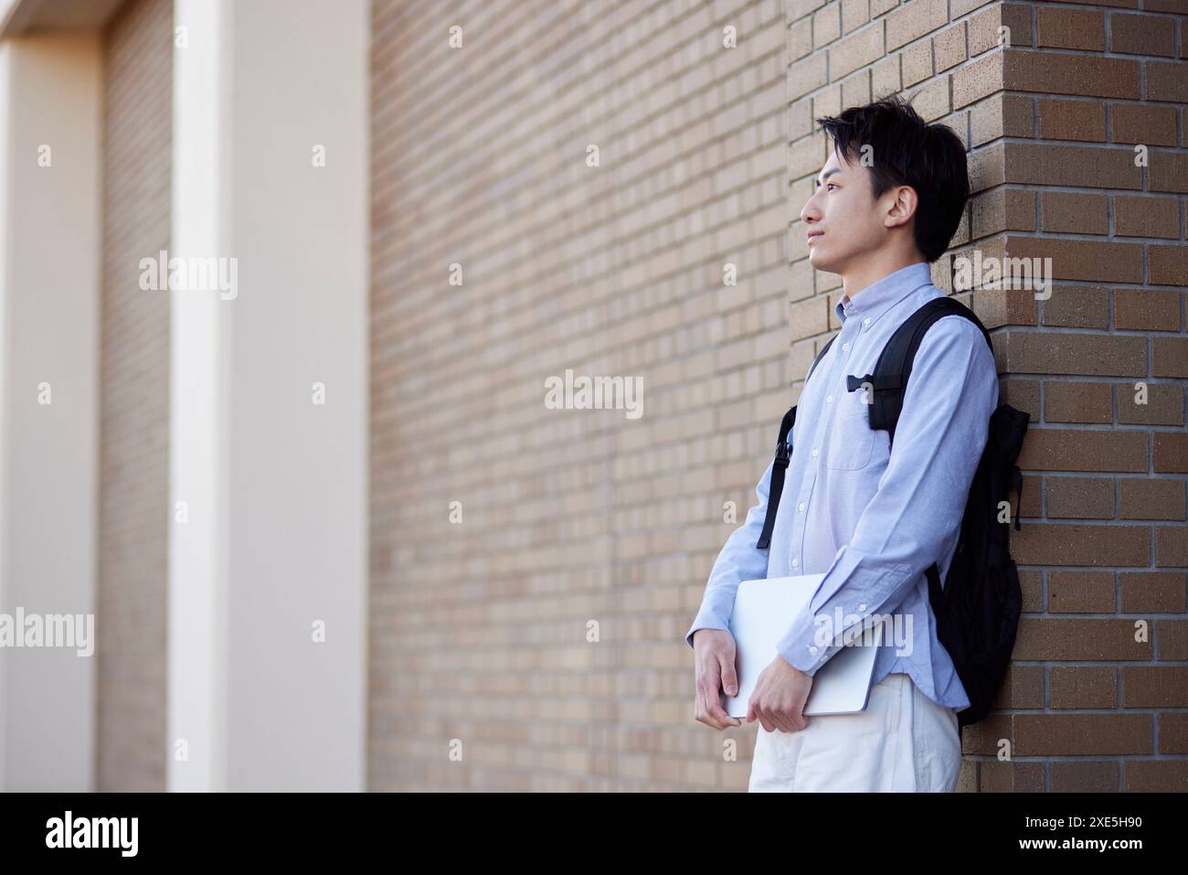 Young student carrying backpack hi-res stock photography and images - Alamy