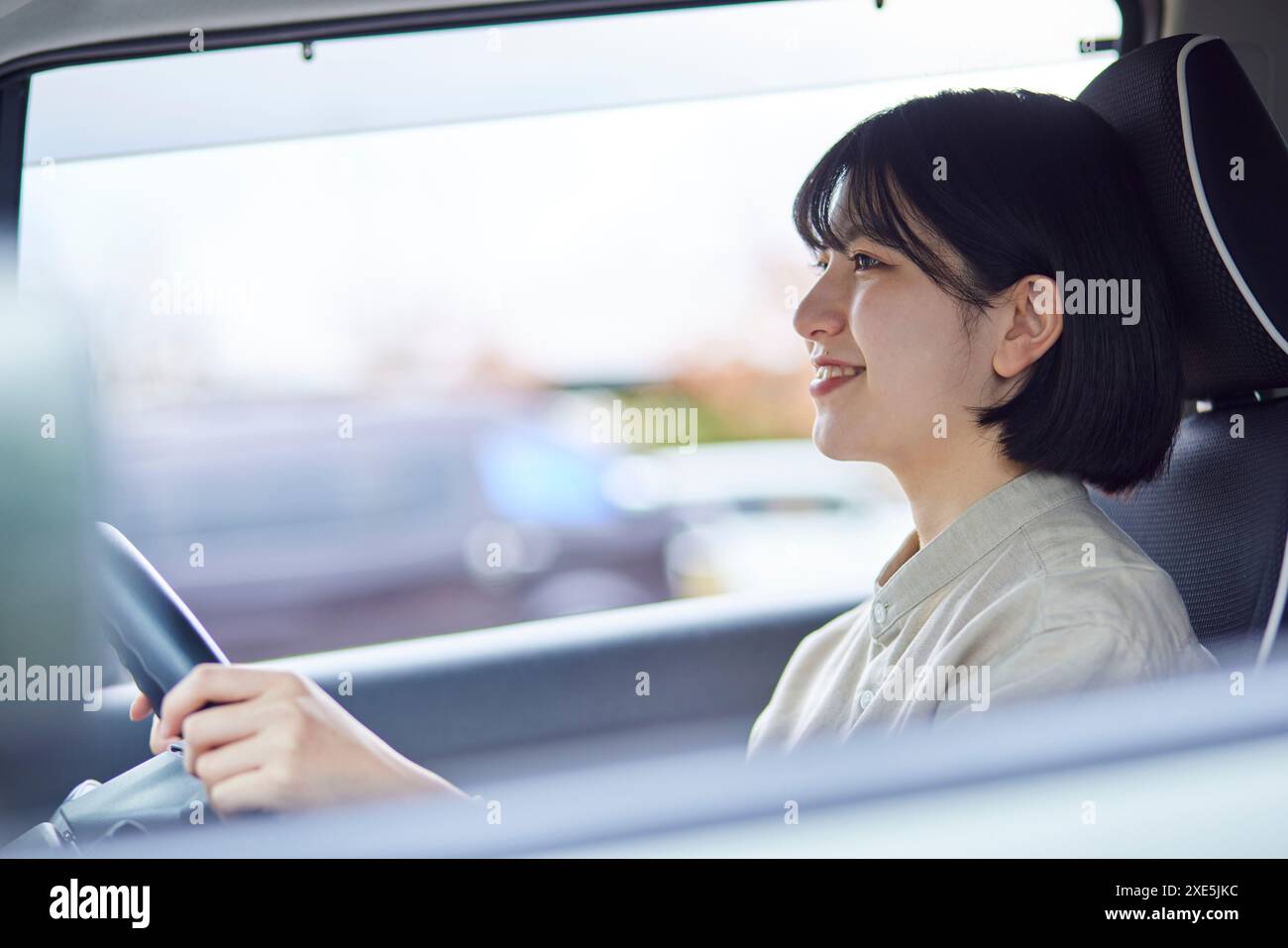 Young Japanese woman driving a car Stock Photo - Alamy