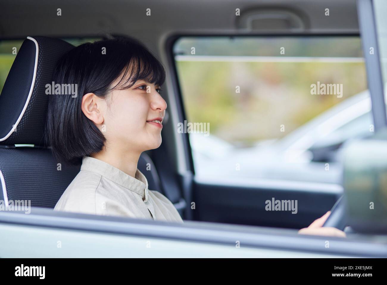 Young Japanese woman driving a car Stock Photo - Alamy