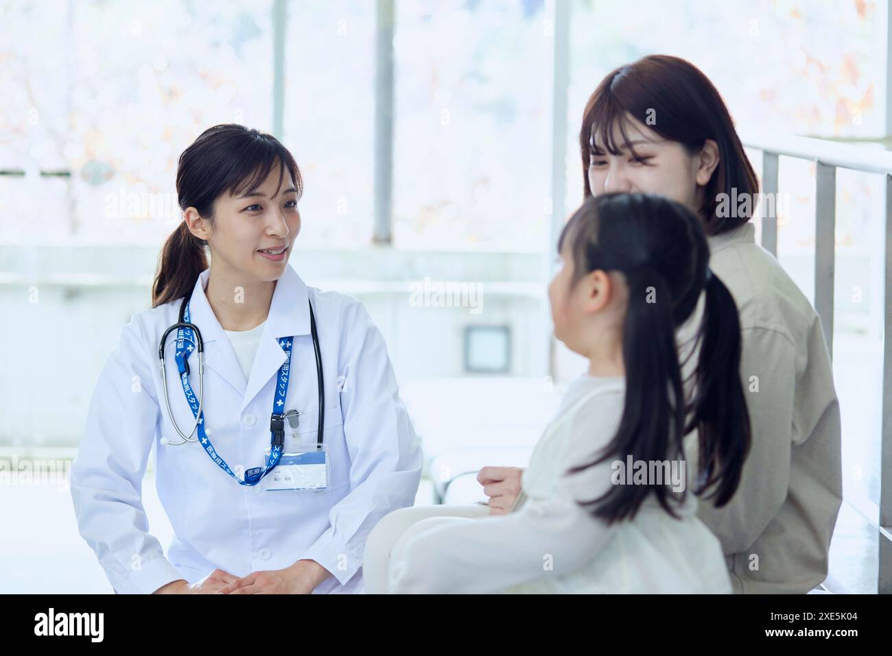 Patient parent and child with doctor Stock Photo - Alamy