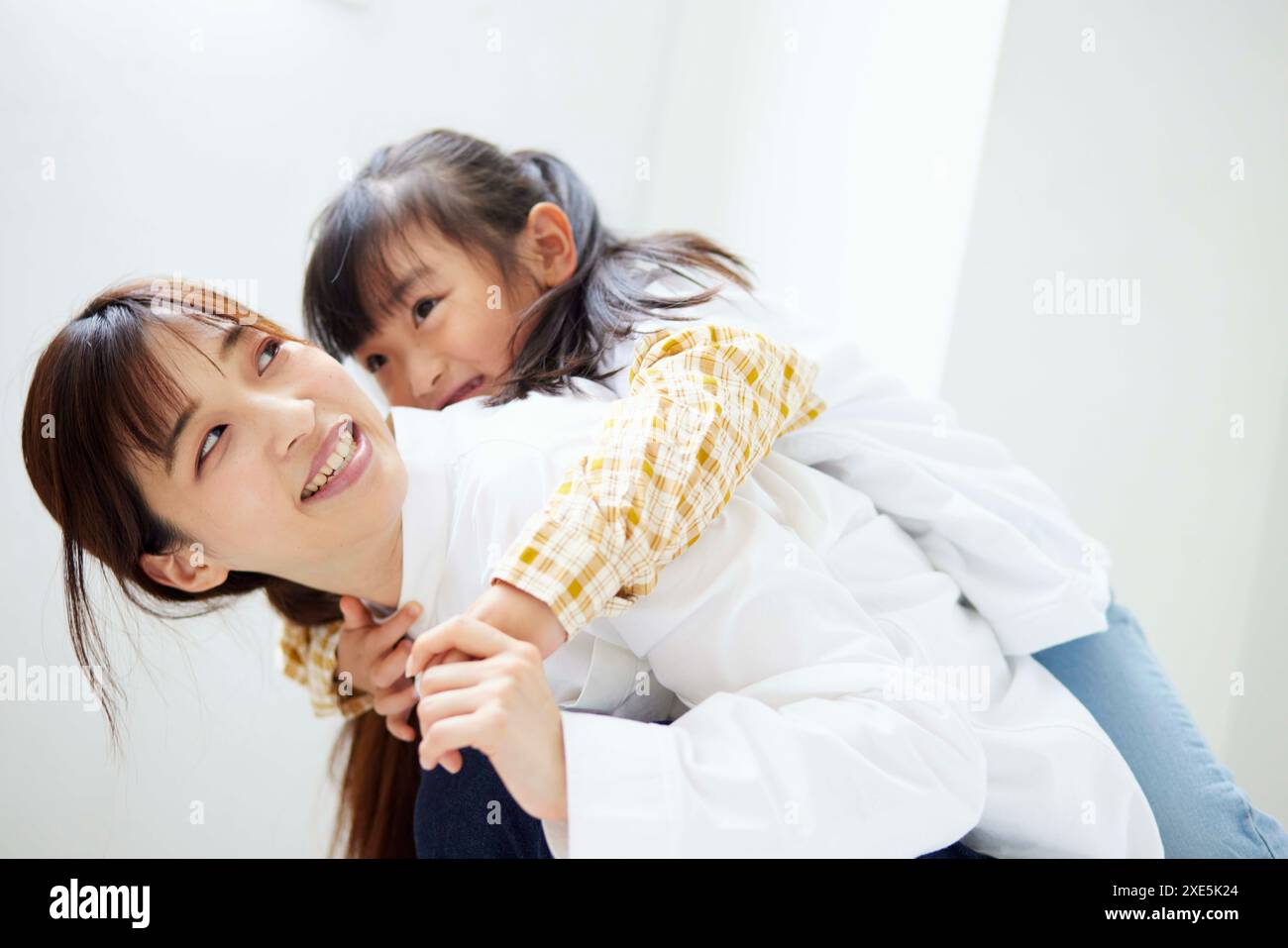 Happy Japanese parents and children playing in the living room Stock Photo - Alamy