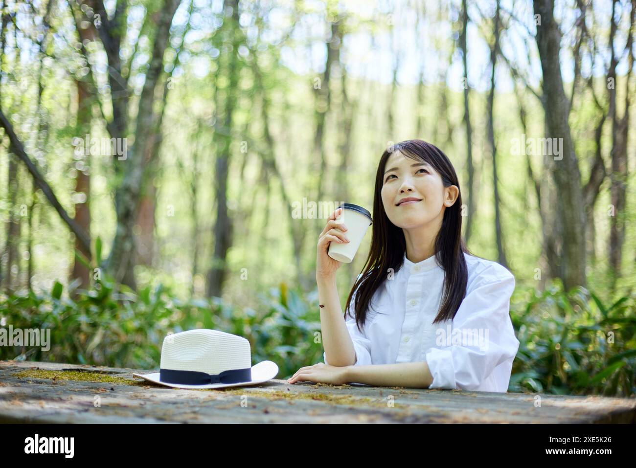 Woman drinking coffee forest hi-res stock photography and images - Alamy