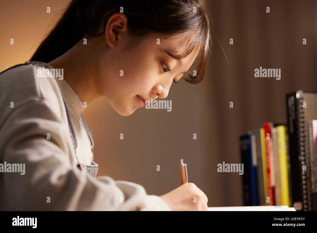 High school girl studying for an exam in her room Stock Photo - Alamy