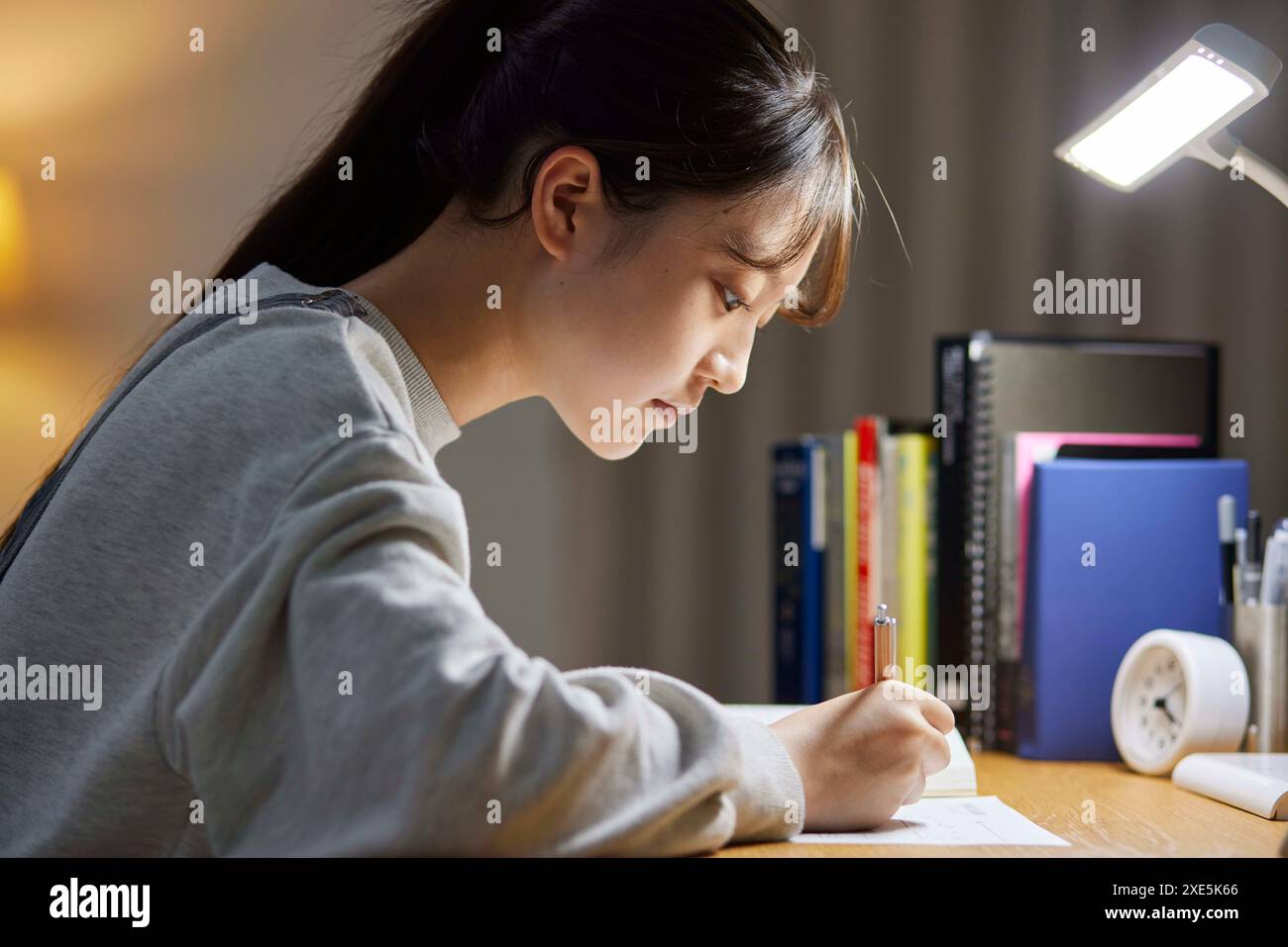 High school girl studying for an exam in her room Stock Photo - Alamy
