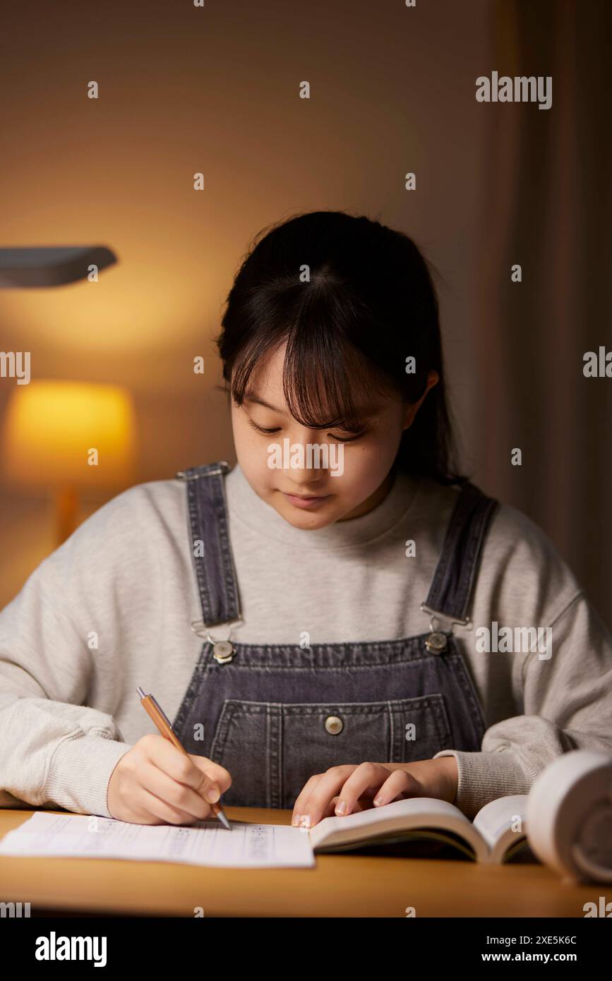 High school girl studying for an exam in her room Stock Photo - Alamy